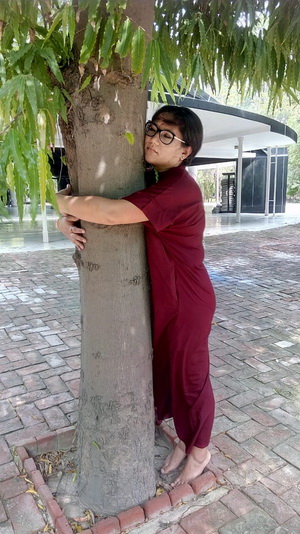 Asha hugging a tree | Osho News