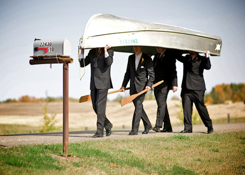 Four men carrying a boat | Osho News