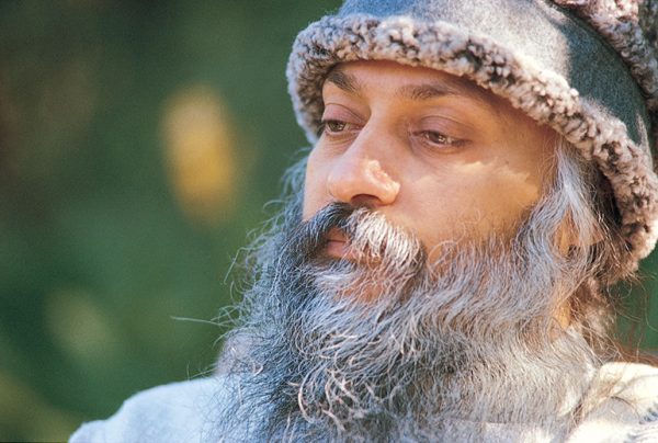 Osho in garden with grey hat | Osho News